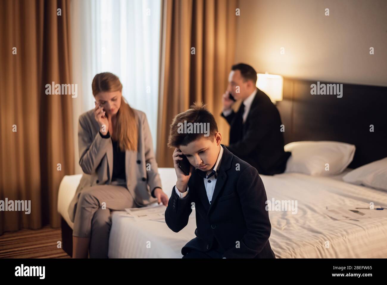 A family talking on their phones in the bedroom Stock Photo - Alamy