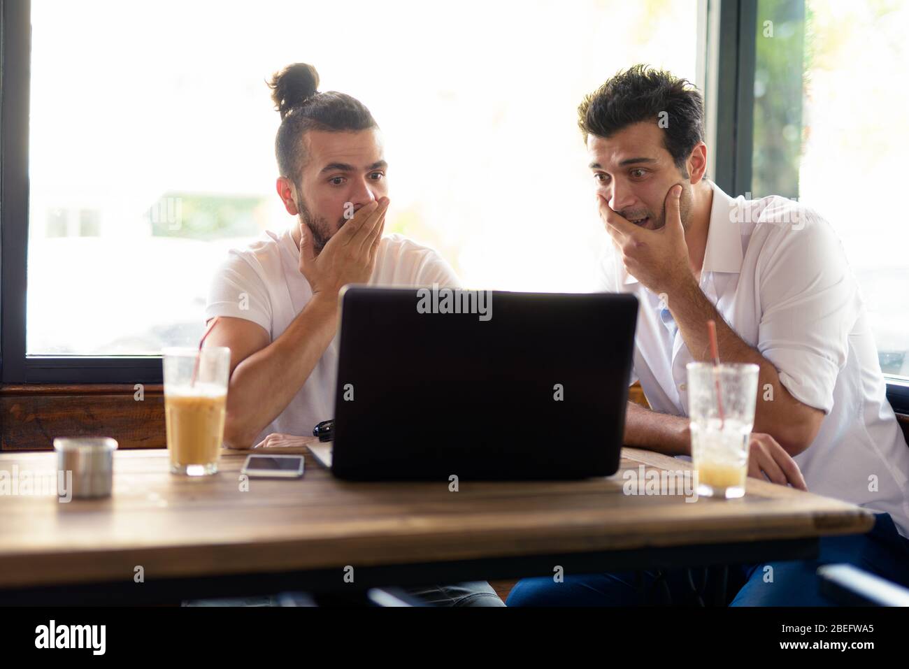 Two handsome Turkish men hanging out and relaxing at the coffee shop ...