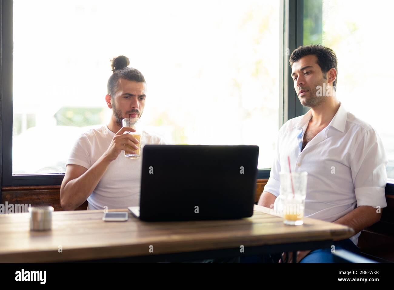 Two handsome Turkish men hanging out and relaxing at the coffee shop ...