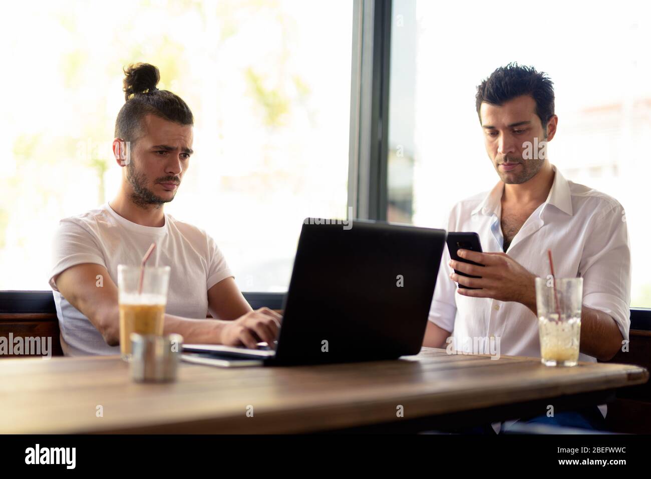 Two handsome Turkish men hanging out and relaxing at the coffee shop ...