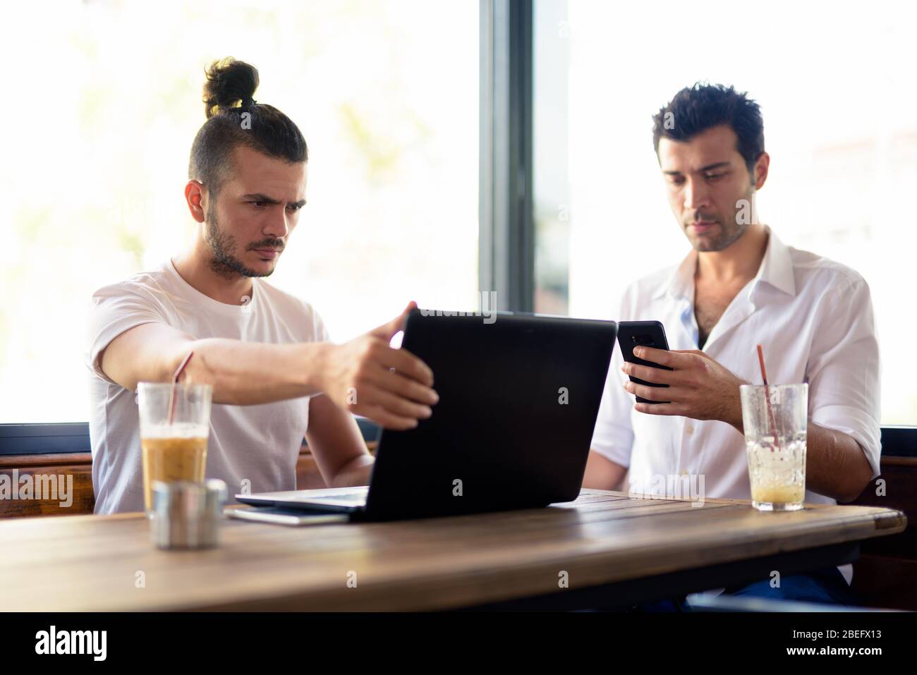 Two handsome Turkish men hanging out and relaxing at the coffee shop ...