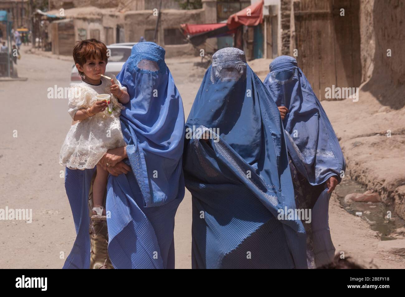 Women in burqas in Kabul walking with a child Stock Photo - Alamy