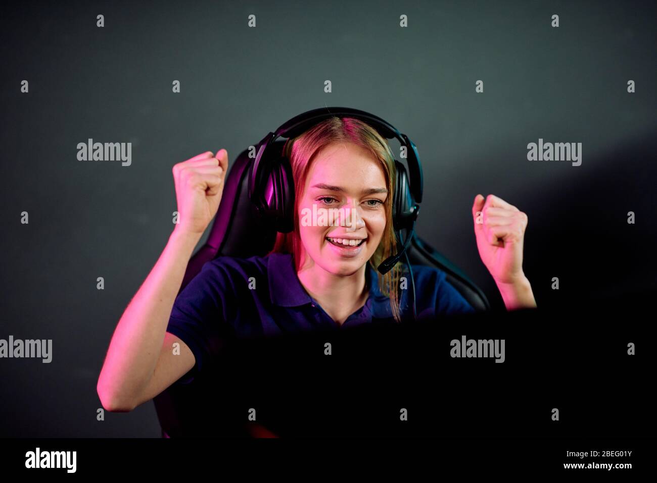 Happy young woman in headphones making yes gesture while celebrating ...
