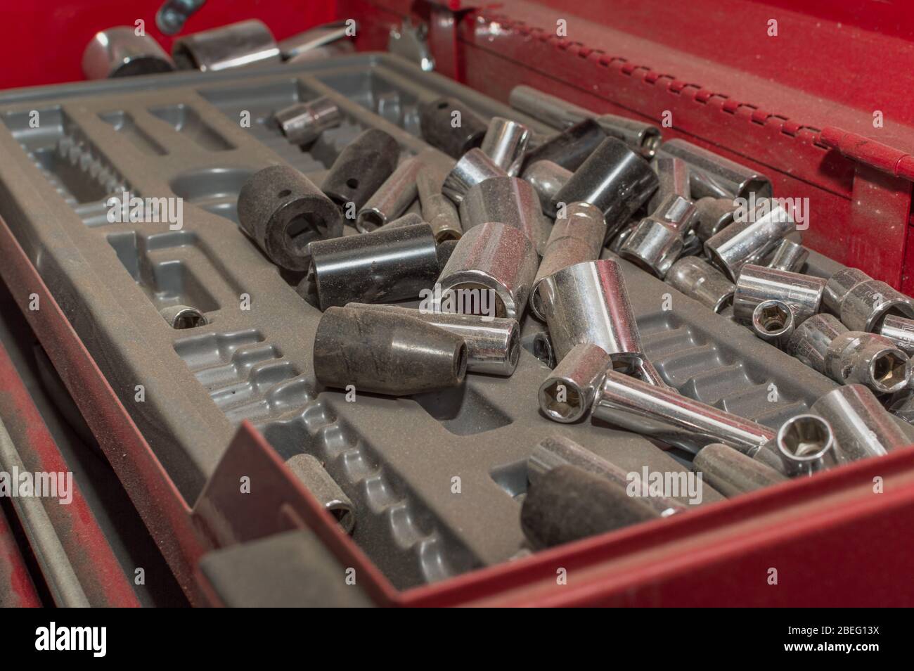 A mechanic's unorganized tray of sockets in a red tool cabinet Stock ...