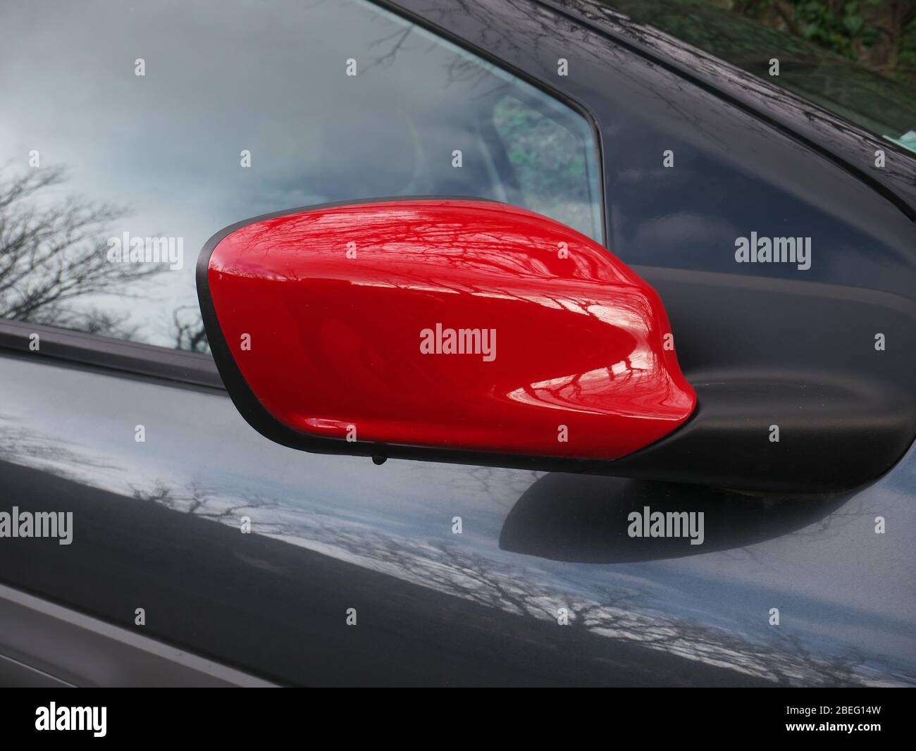 Red rear side mirror. Right side. Trees reflection on the window Stock ...