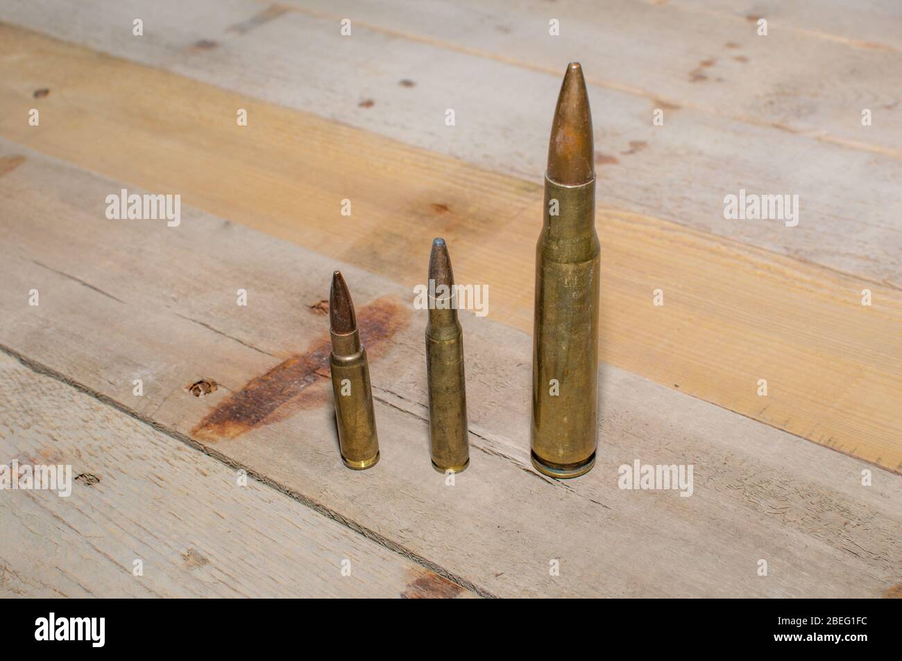 Three different caliber rifle bullets standing beside each other ...