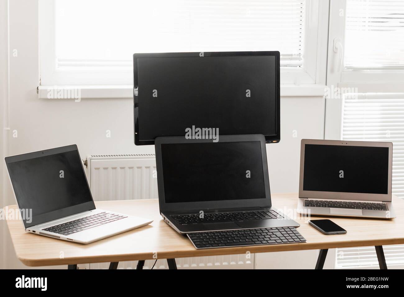 Three computers are on the desk. Home office concept. Video makers work ...