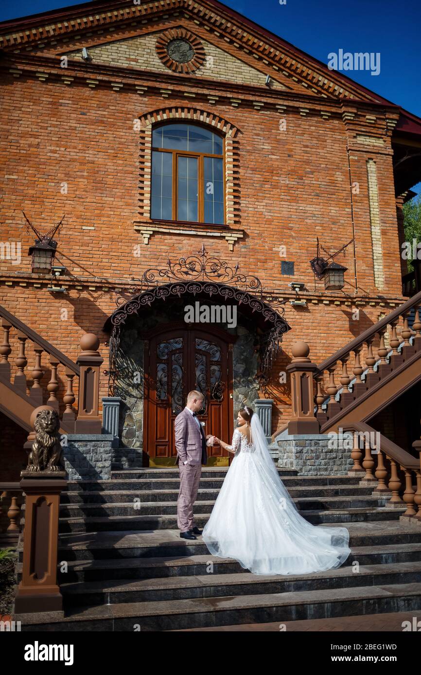The bride in a white wedding dress and groom in a suit on the ...