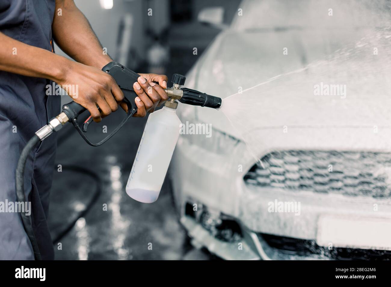 Manual car washing concept. Cropped image of hands of young dark ...