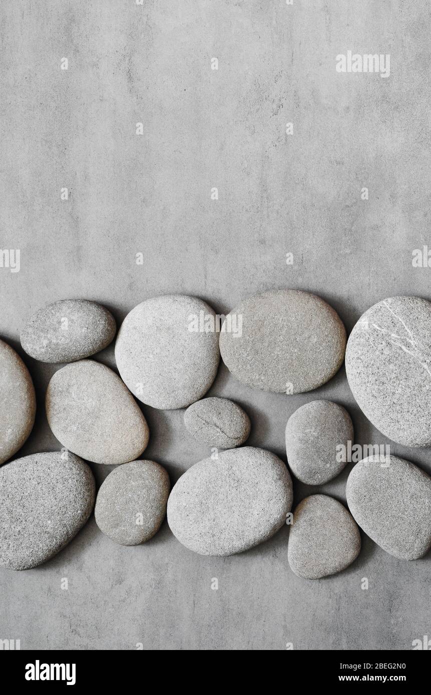 Gray spa stones and grey background. Spa concept Stock Photo - Alamy
