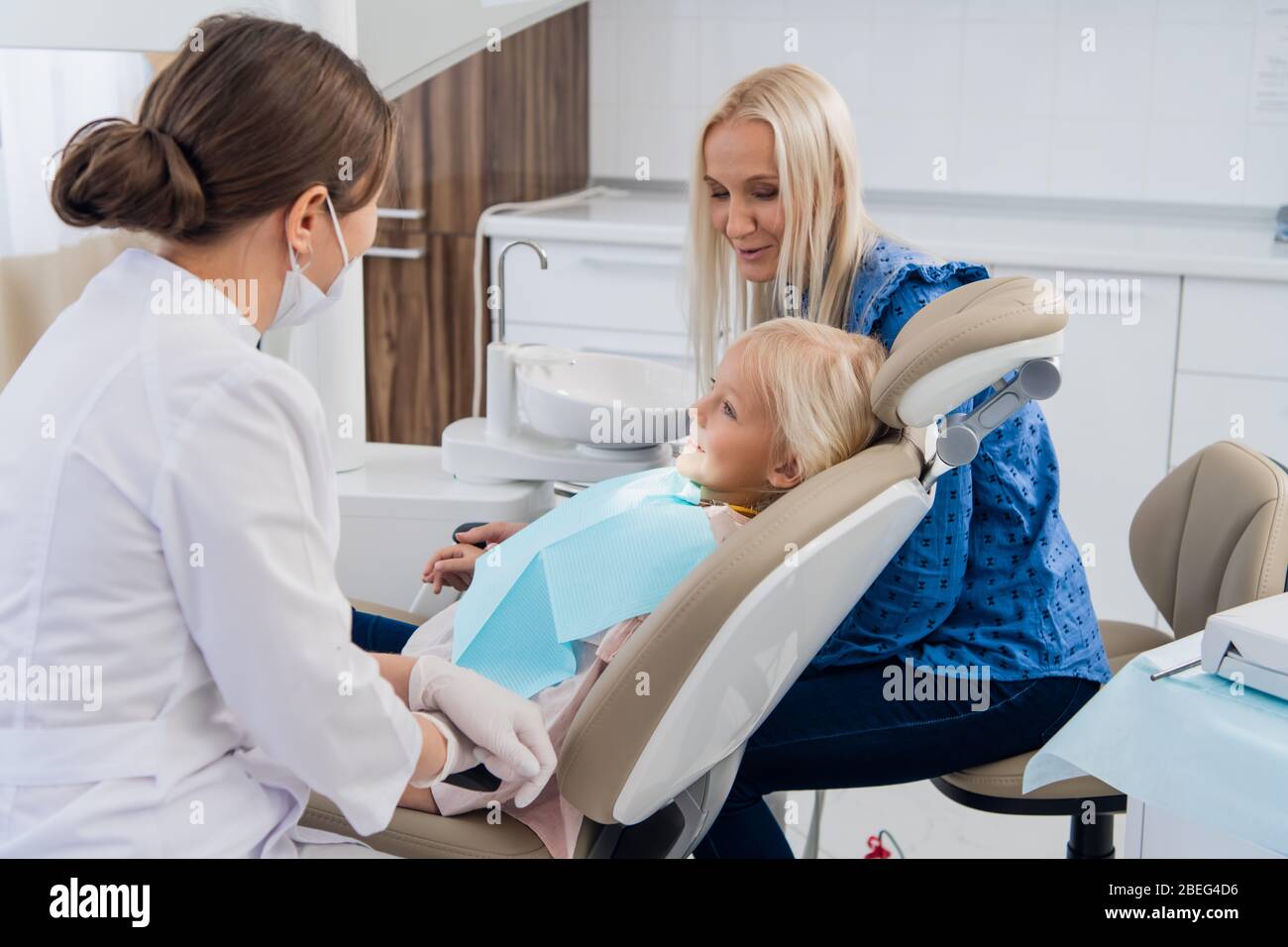 A child having a dental checkup with her mother Stock Photo - Alamy