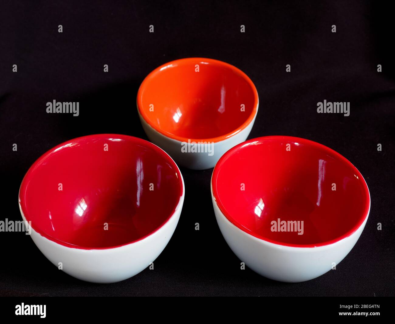 Three Red and White Dipping bowls set on a black background Stock Photo ...