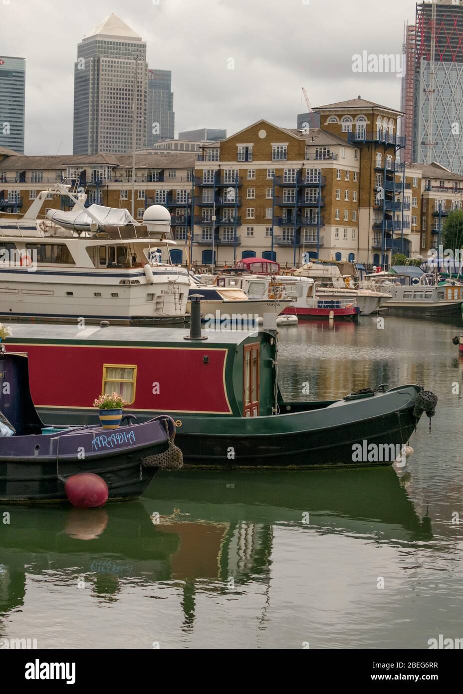 Moored boats at Limehouse Basin Marina with residential buildings and ...