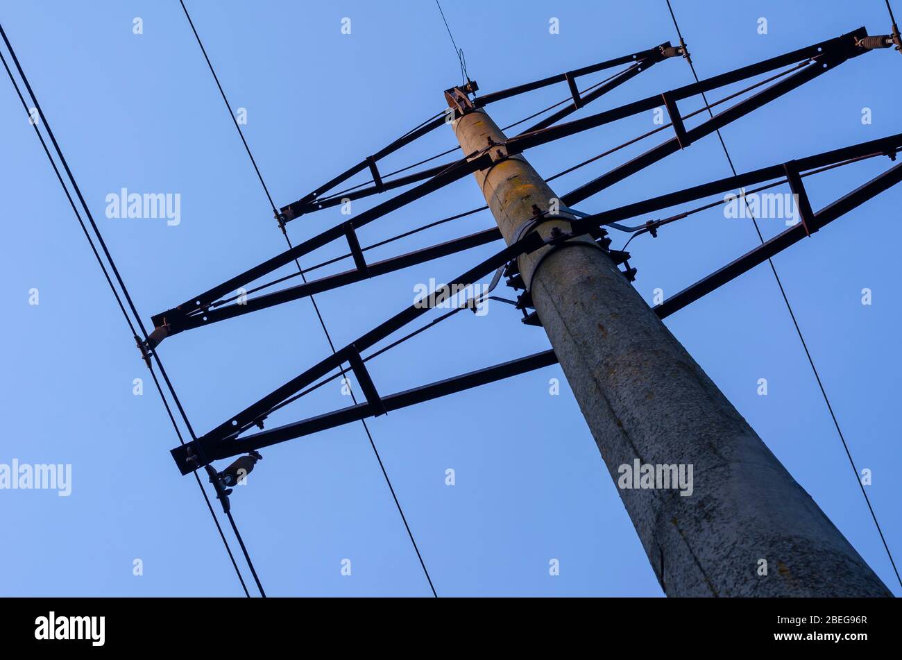 Concrete pillar power line with steel traverses, porcelain insulators ...