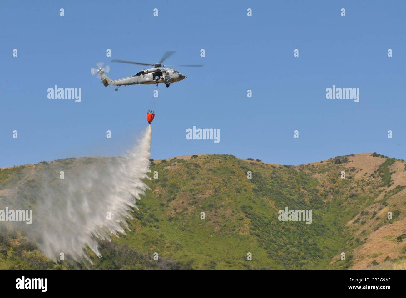 Helicopter drops water during exercise Stock Photo - Alamy