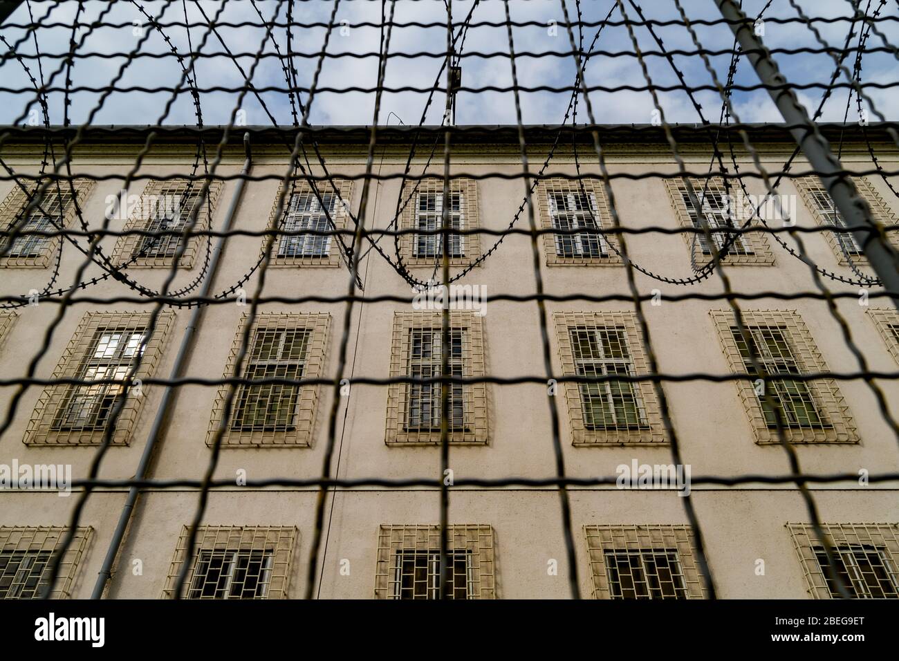 Prison windows and barbed wire fence Stock Photo - Alamy
