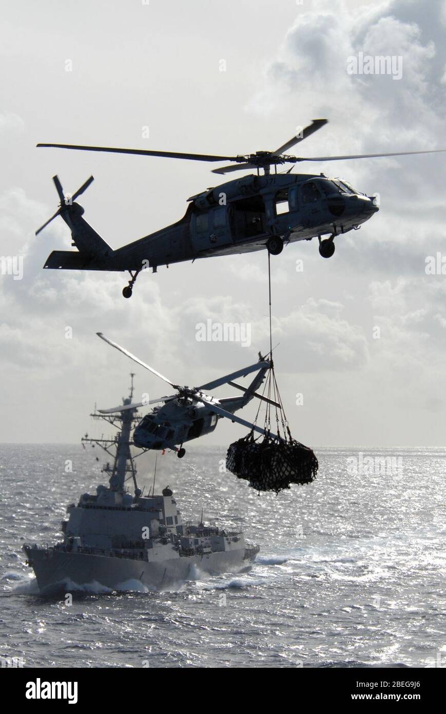Helicopters and ships work together on vertical replenishment Stock ...