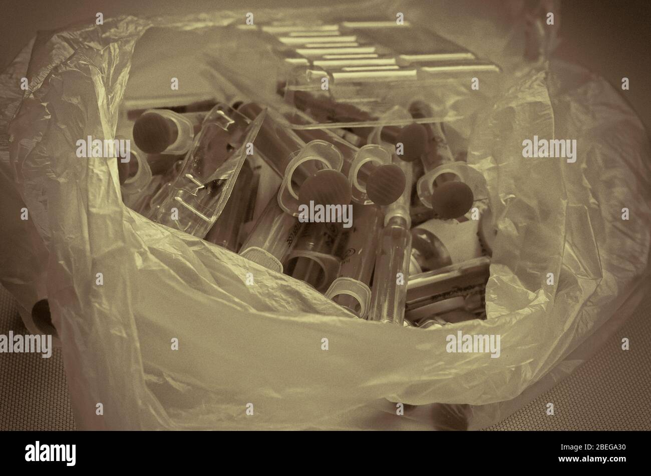 Used syringes, vials and ampoules in a bag. Plastic bag with medical ...