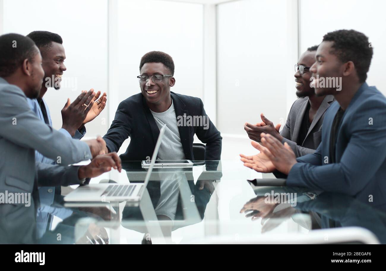 project Manager explaining something to employees at an office meeting ...