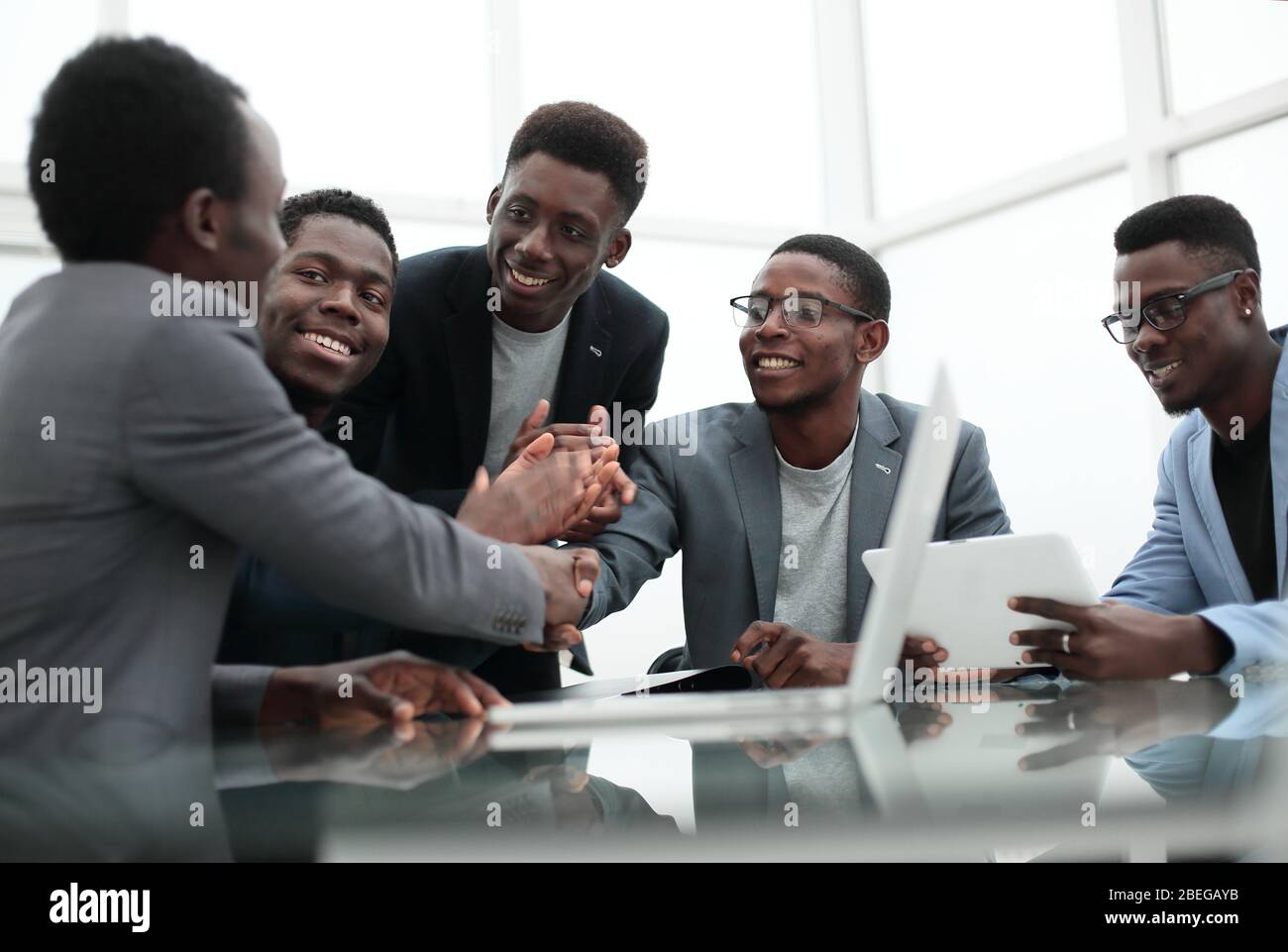 group of employees looking at the screen of a digital tablet Stock ...