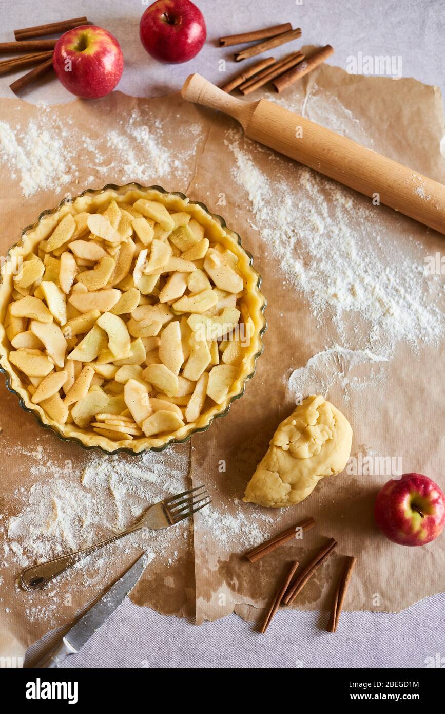 Homemade rustic apple pie preparation on white kitchen background. Flat ...