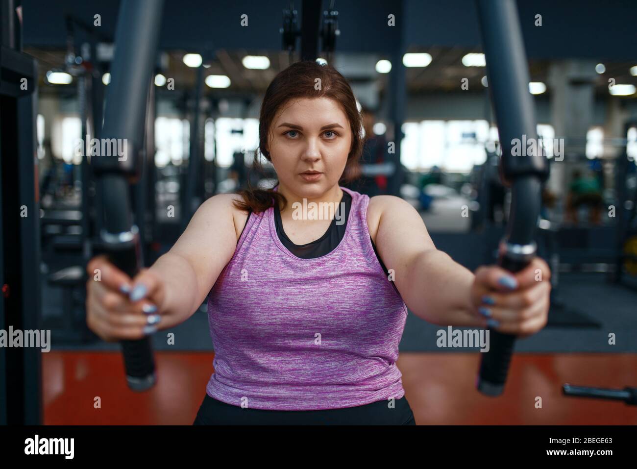 Overweight woman on exercise machine, top view Stock Photo - Alamy