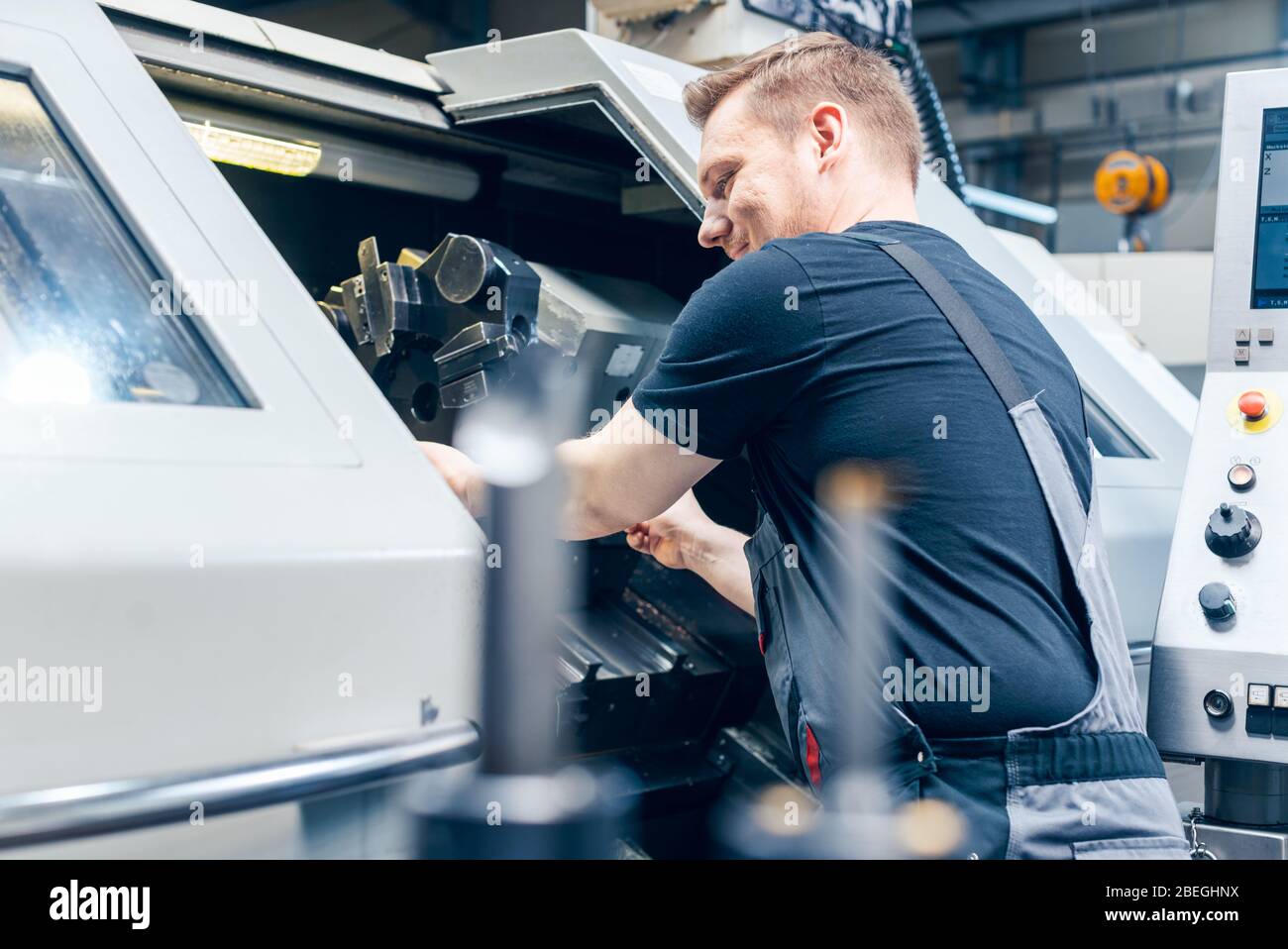 Experienced worker changing tool setup of lathe machine Stock Photo - Alamy