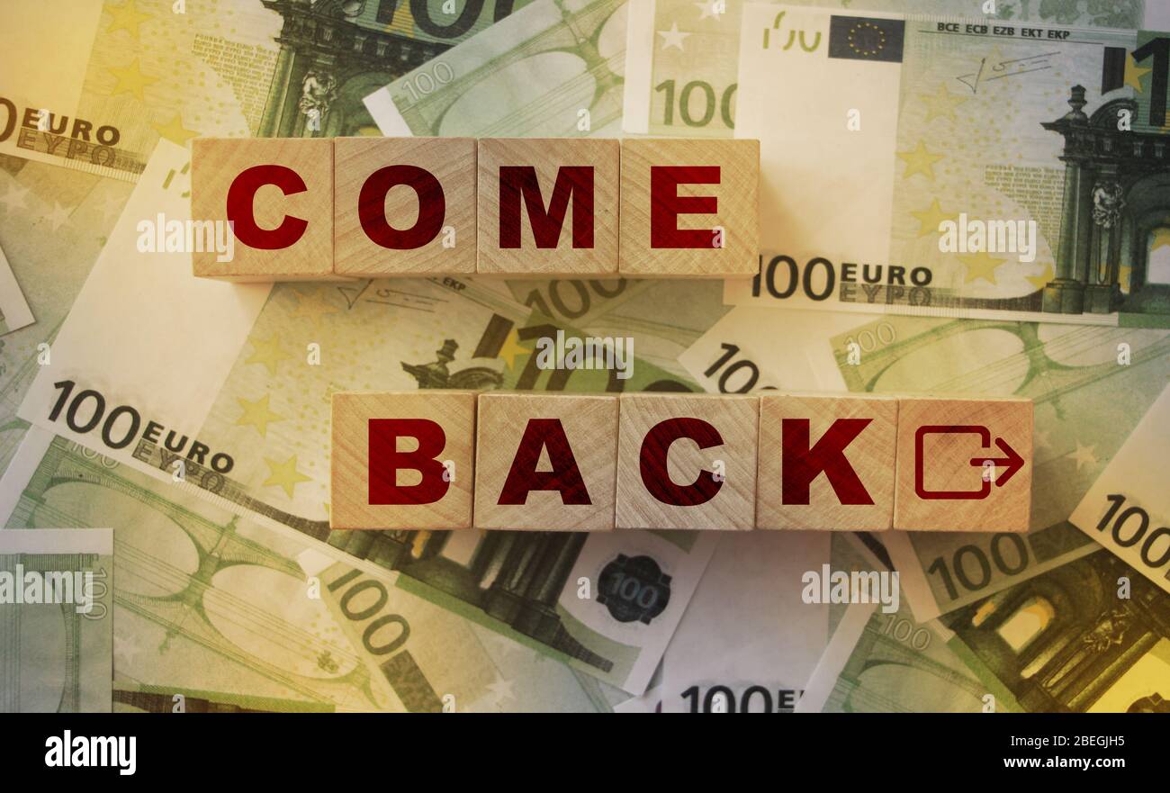 Come back words on wooden cubes standing on 100 euro banknotes ...