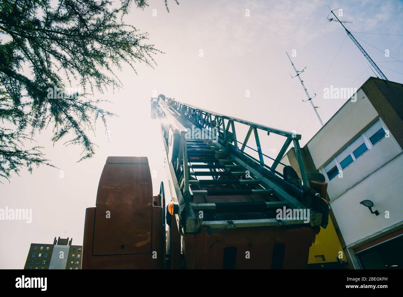 Firemen at the top of the truck ladder performing an emergency Stock ...