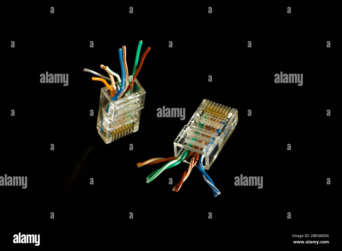 Cut LAN cable connectors with wires isolated on the black background ...