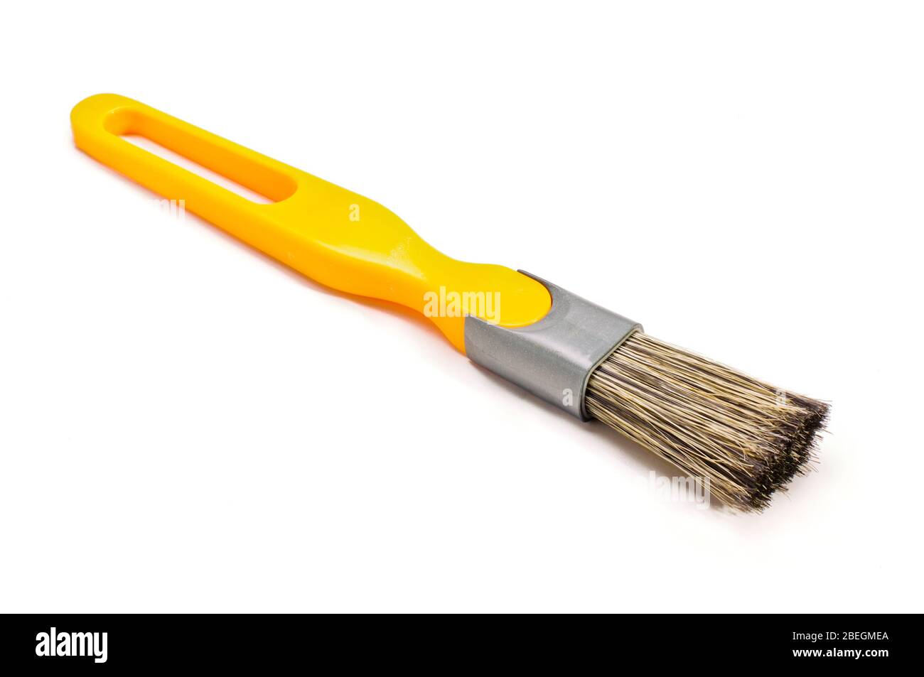 Brand new yellow plastic painting brush isolated on the white ...