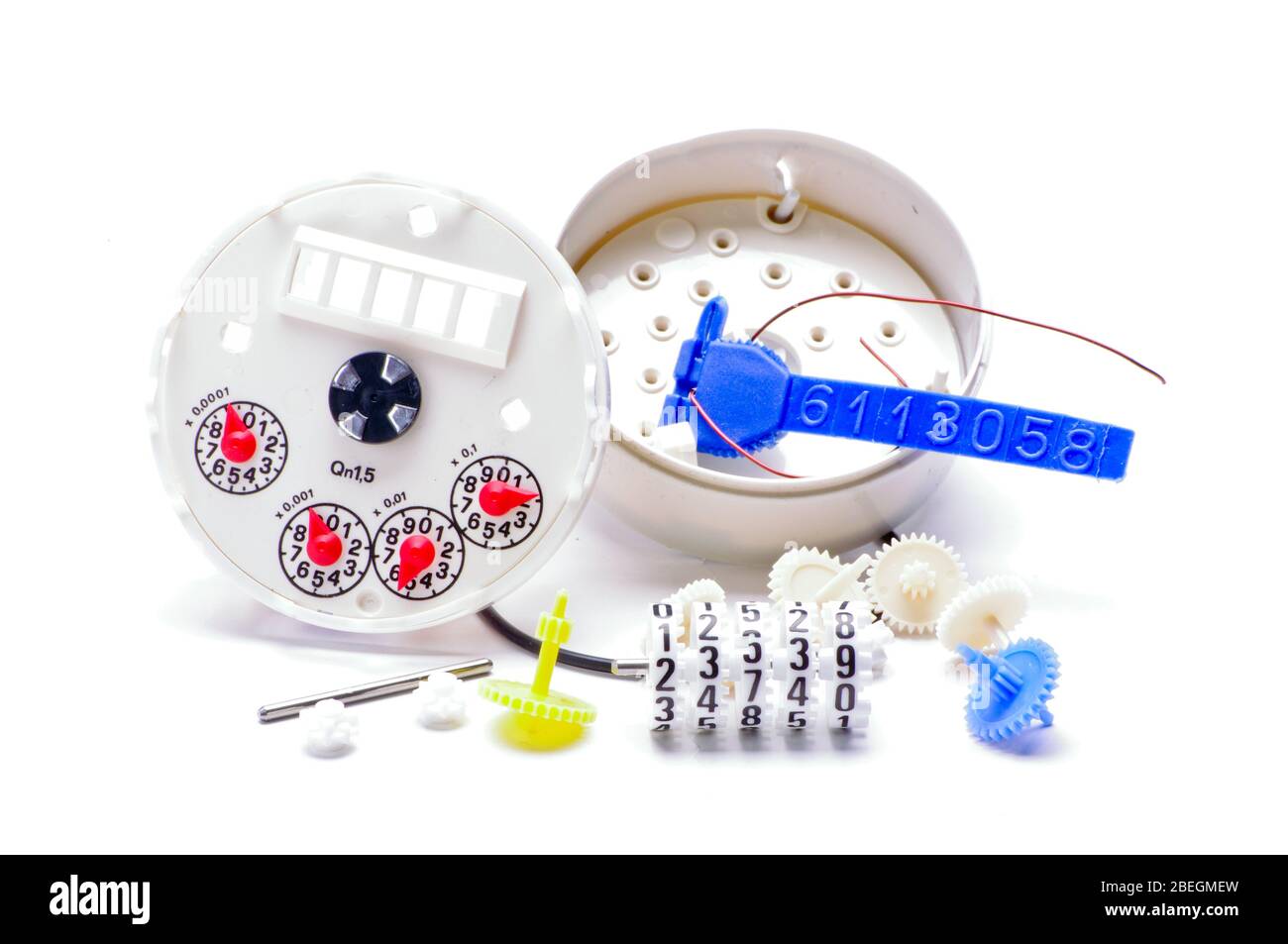 Internal mechanical parts from broken water meter isolated on the white ...