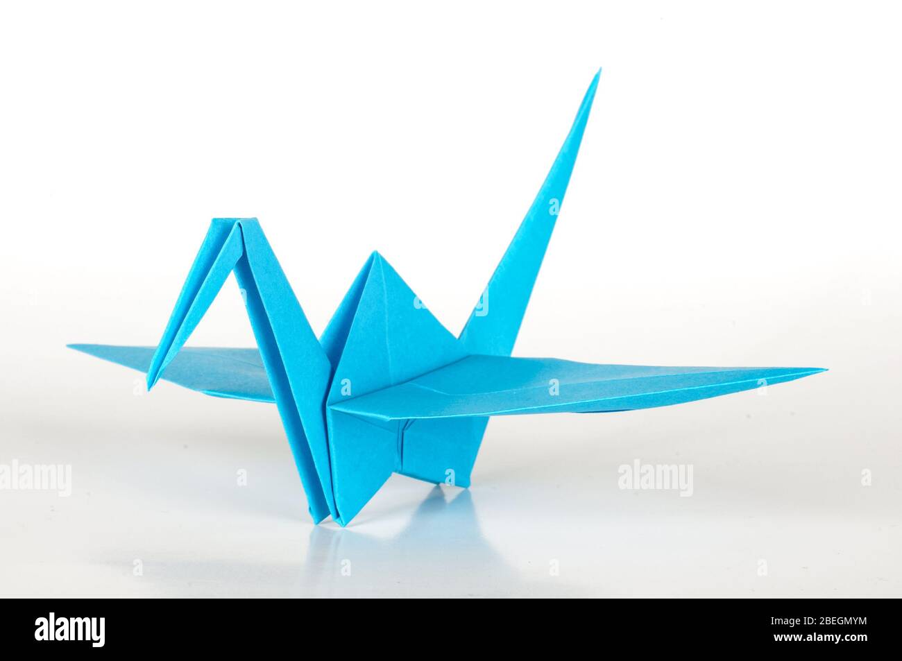 Blue japanese origami style crane bird folded from paper Stock Photo ...