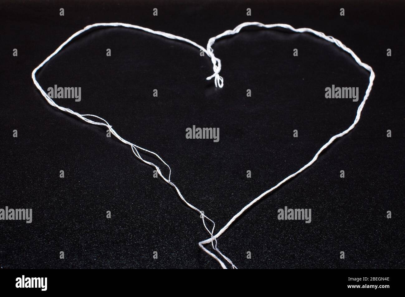 String shaped in the heart shape isolated on the black background Stock ...