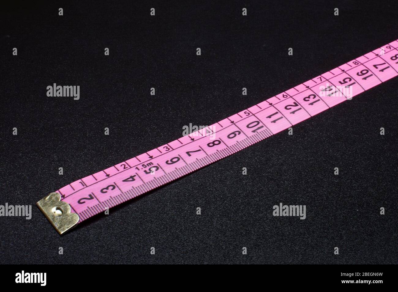 Pink measurement tape close up isolated on the black background Stock ...