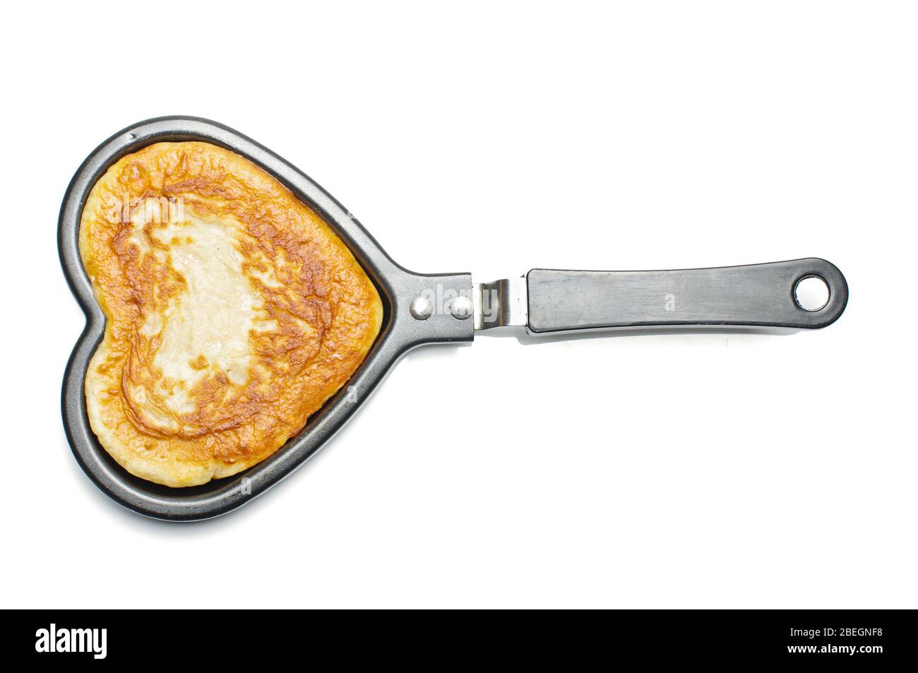 Heart shape flapjack in the pan isolated on the white background Stock ...