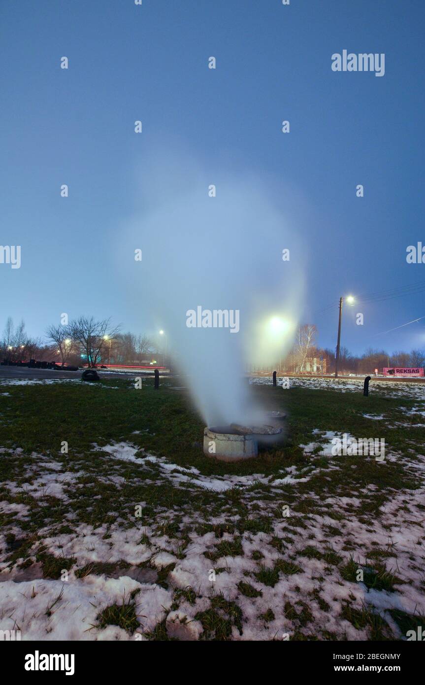 Toxic steam from well on the street. Pollution concept Stock Photo - Alamy