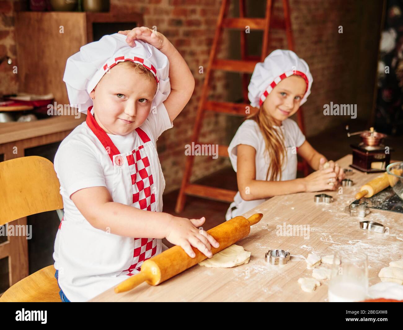 Two kids cooking in a domestic kitchen. Happy family, happy children ...