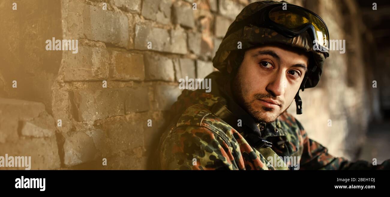 A man is a military soldier in a helmet and camouflage clothing ...