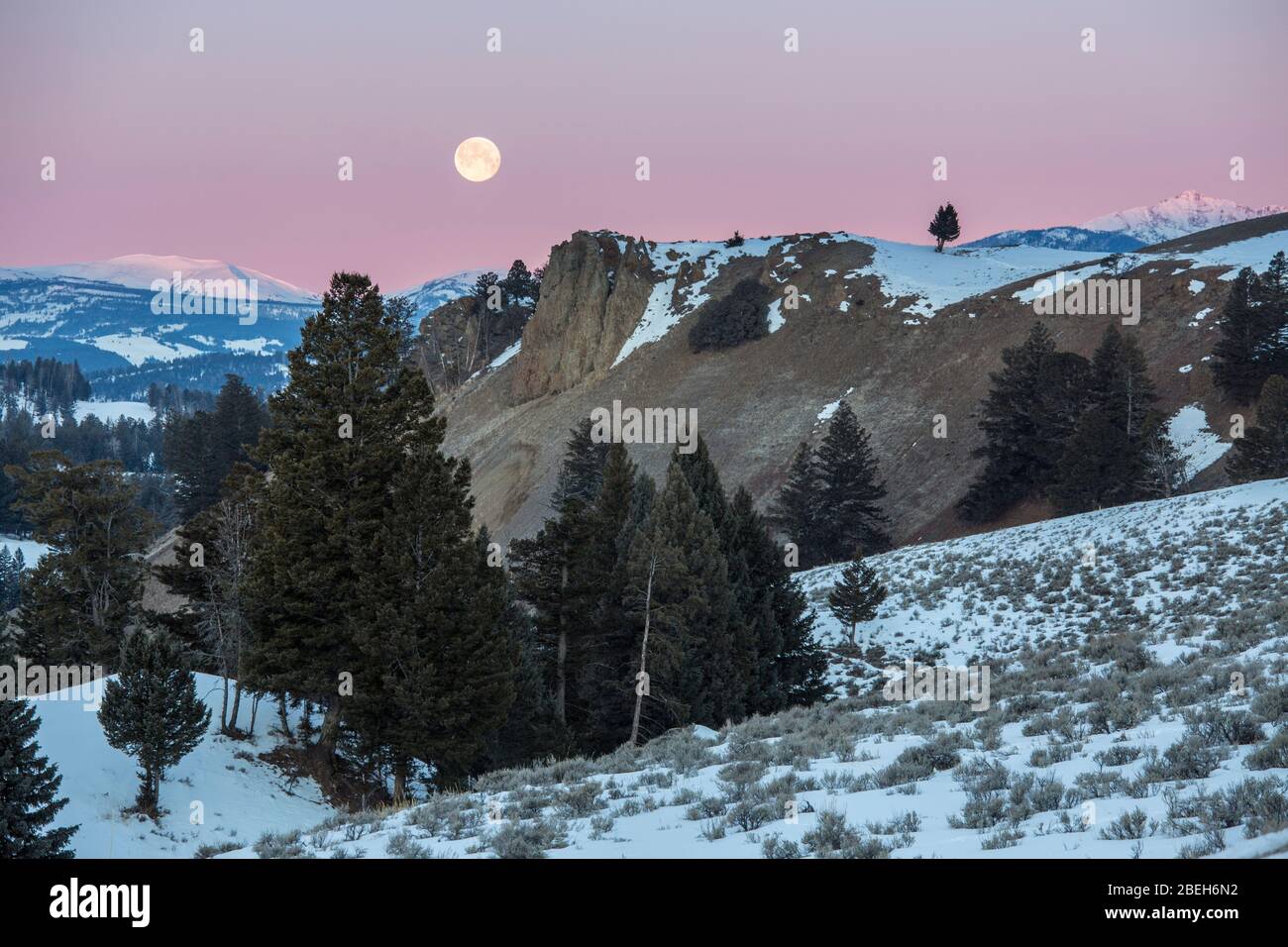 Full moon setting over the Gallatin Range in Yellowstone National Park ...