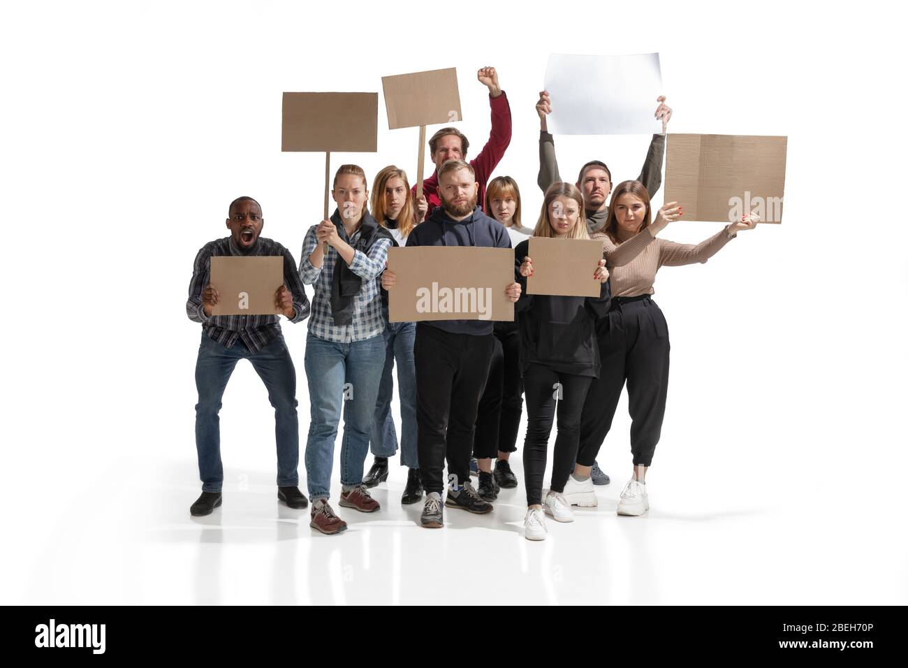 Emotional multicultural group of people screaming while holding blank ...