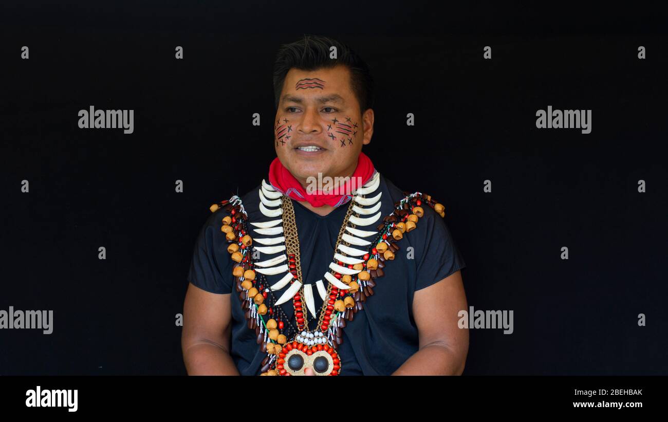 Cofan ethnic man wearing traditional clothing adorned with necklace and ...