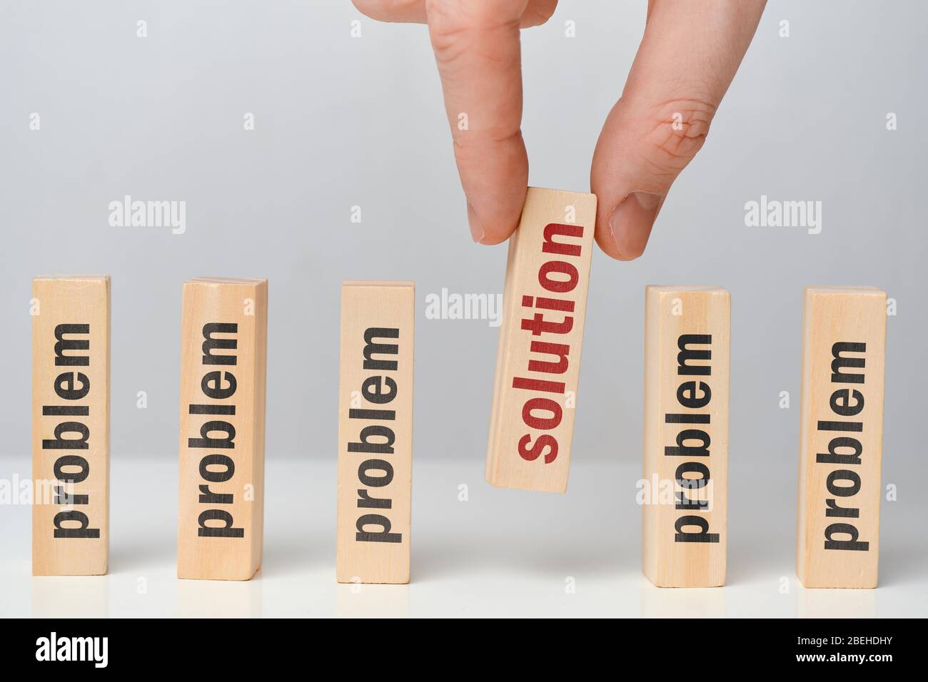 Problem solution concept - hand holds wooden block with the inscription ...