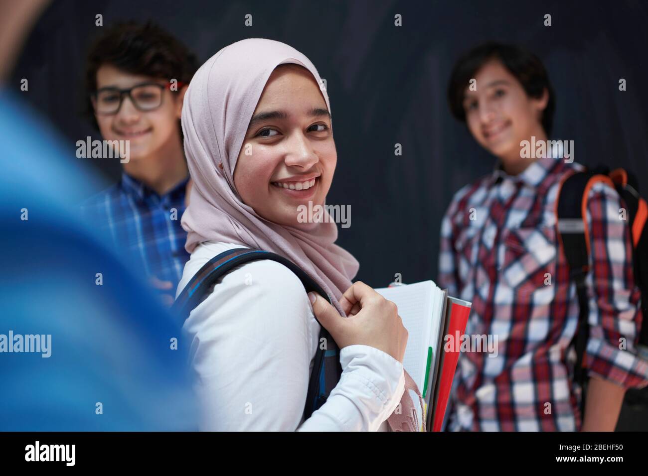 Arabic teenagers, students group portrait against black chalkboard ...