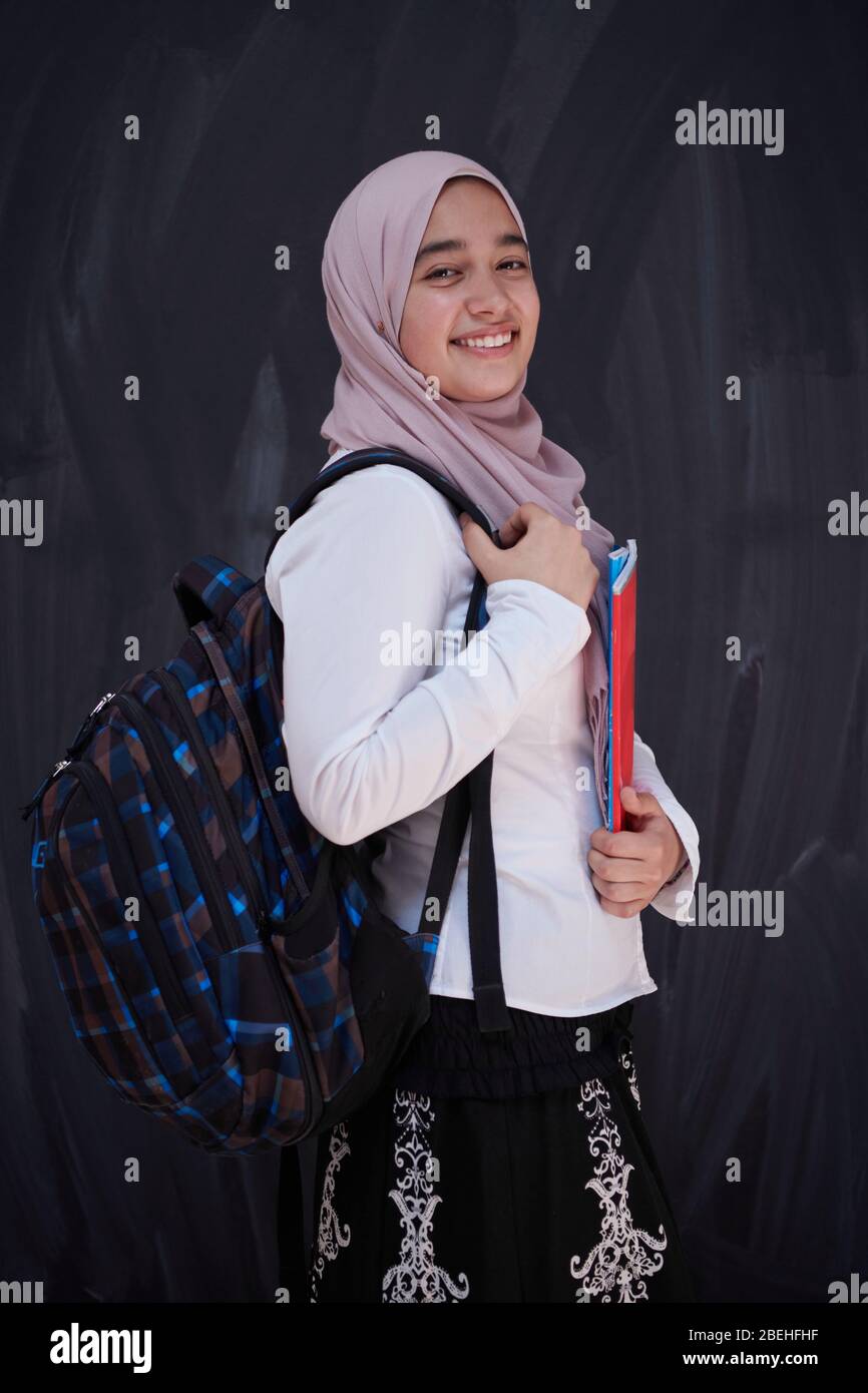 portrait of happy female middle eastern university student against ...