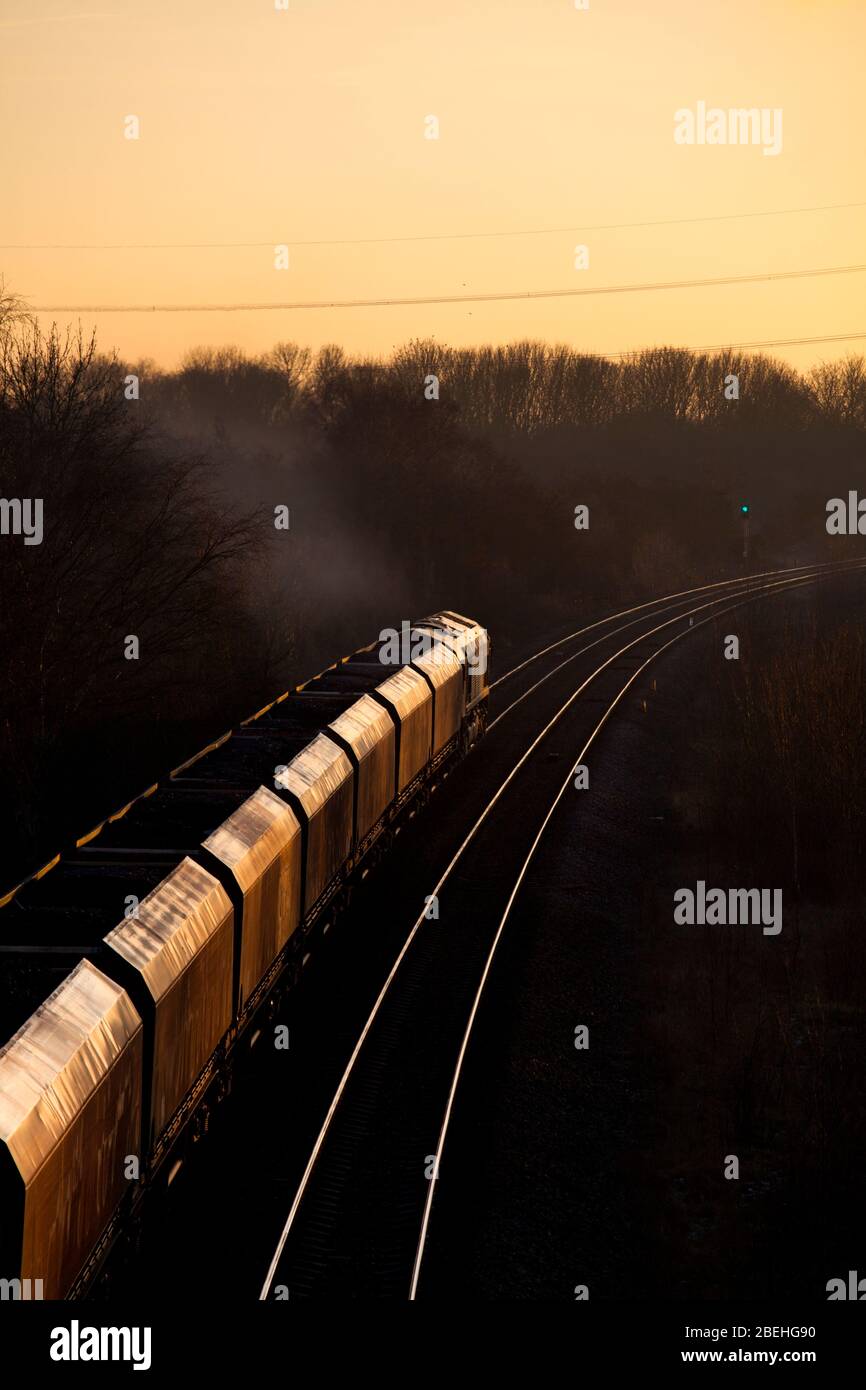 DB Cargo Rail UK merry go round coal freight train heading into the sunset with imported coal ...