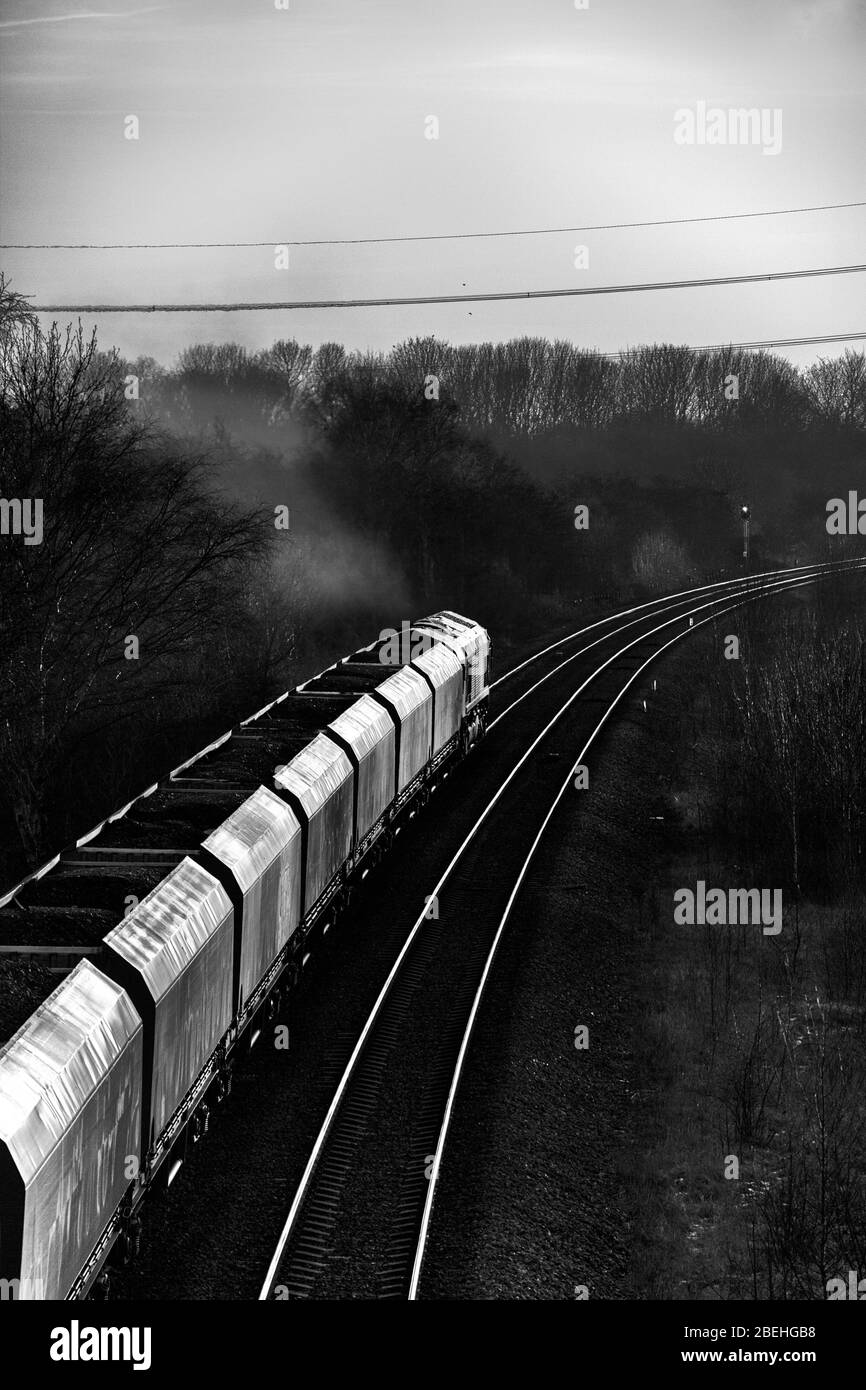 DB Cargo Rail UK merry go round coal freight train heading into the sunset with imported coal ...