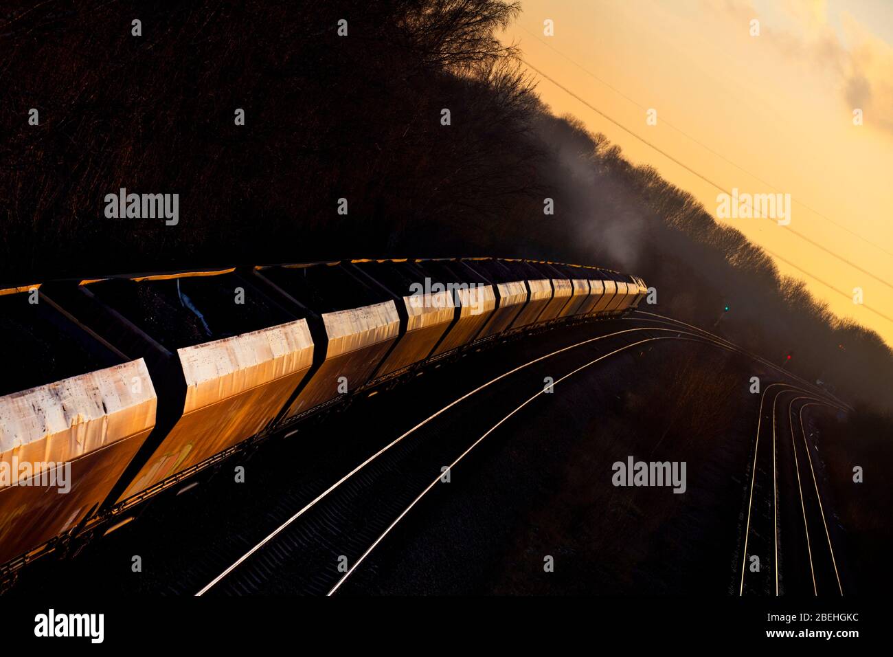 DB Cargo Rail UK merry go round coal freight train heading into the sunset with imported coal ...