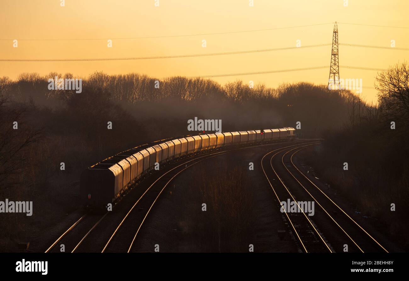 DB Cargo Rail UK merry go round coal freight train heading into the sunset with imported coal ...