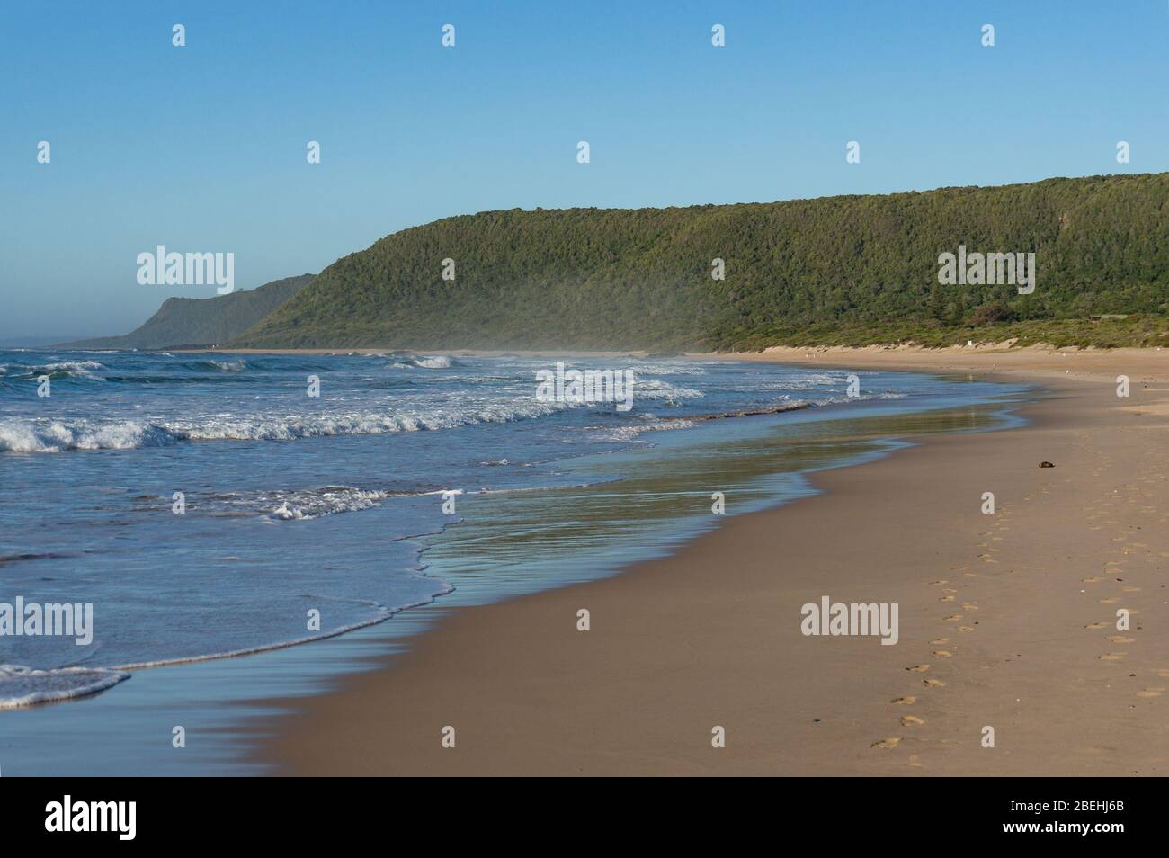 Empty sand beach landscape with waves and sand with footprints. Summer ...